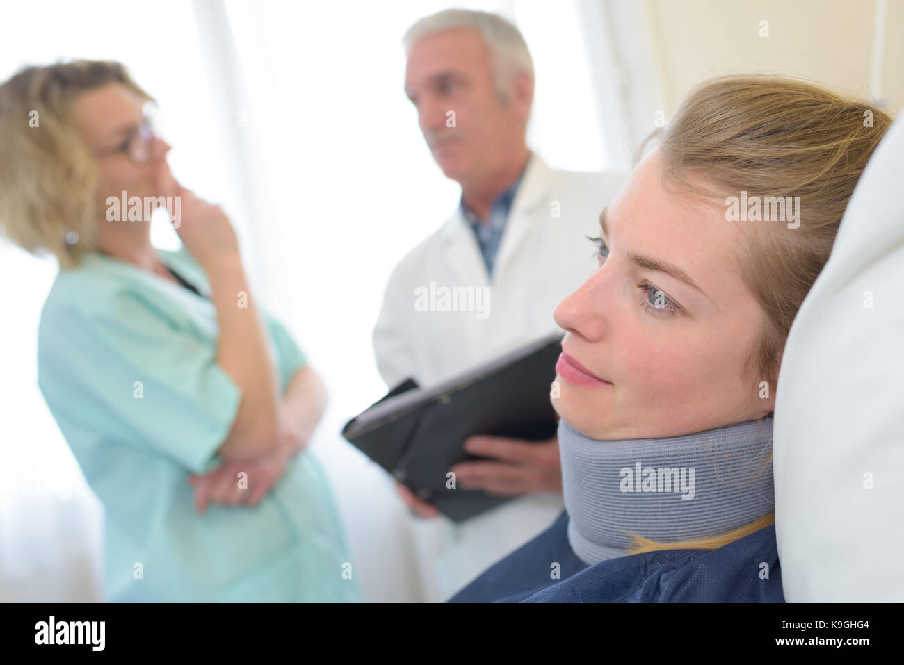 close up female patient wearing neck brace and doctors background Stock ...