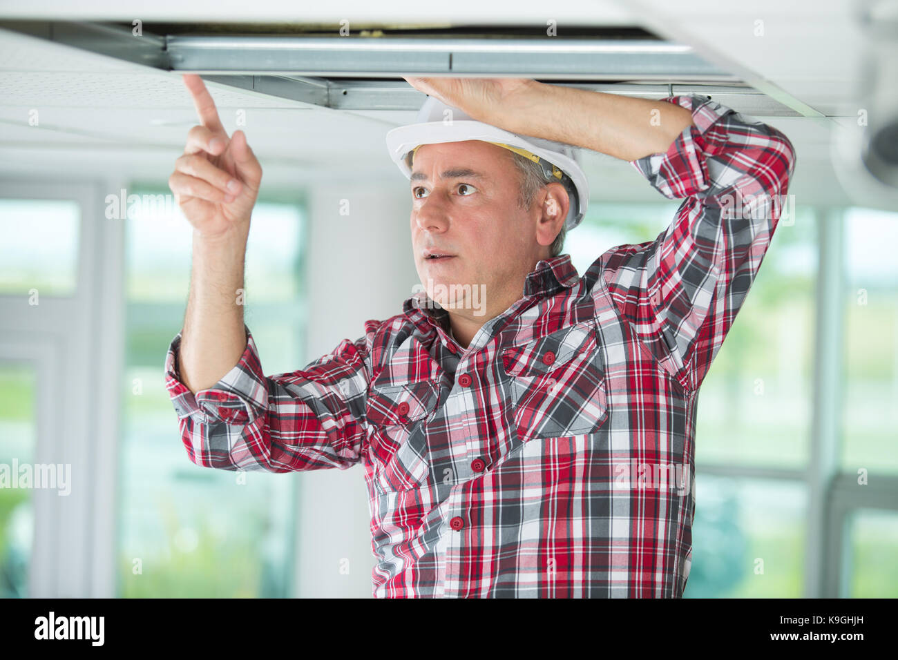 electrician working on ceiling installation Stock Photo - Alamy