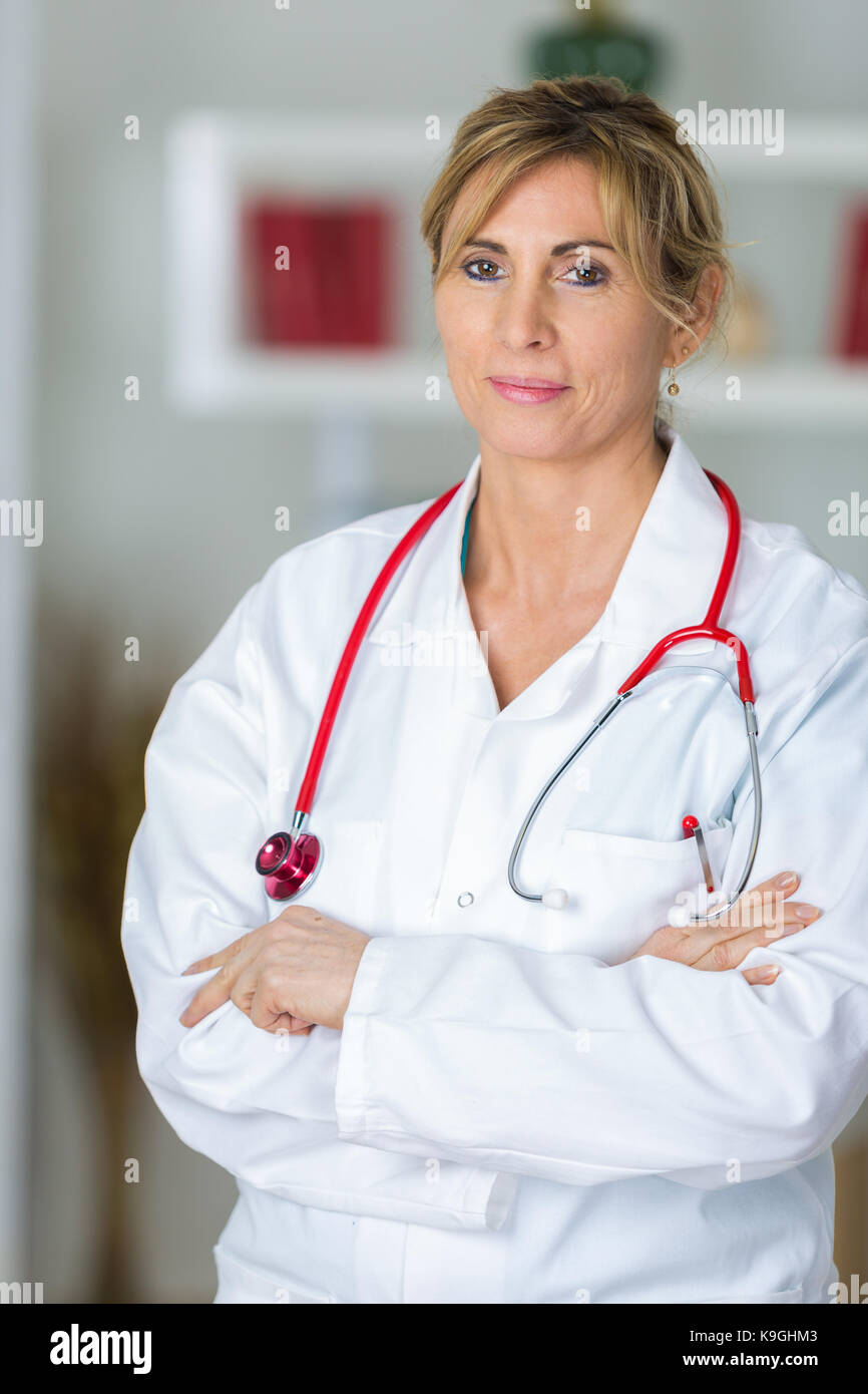 portrait of confident female doctor standing arms crossed in clinic ...