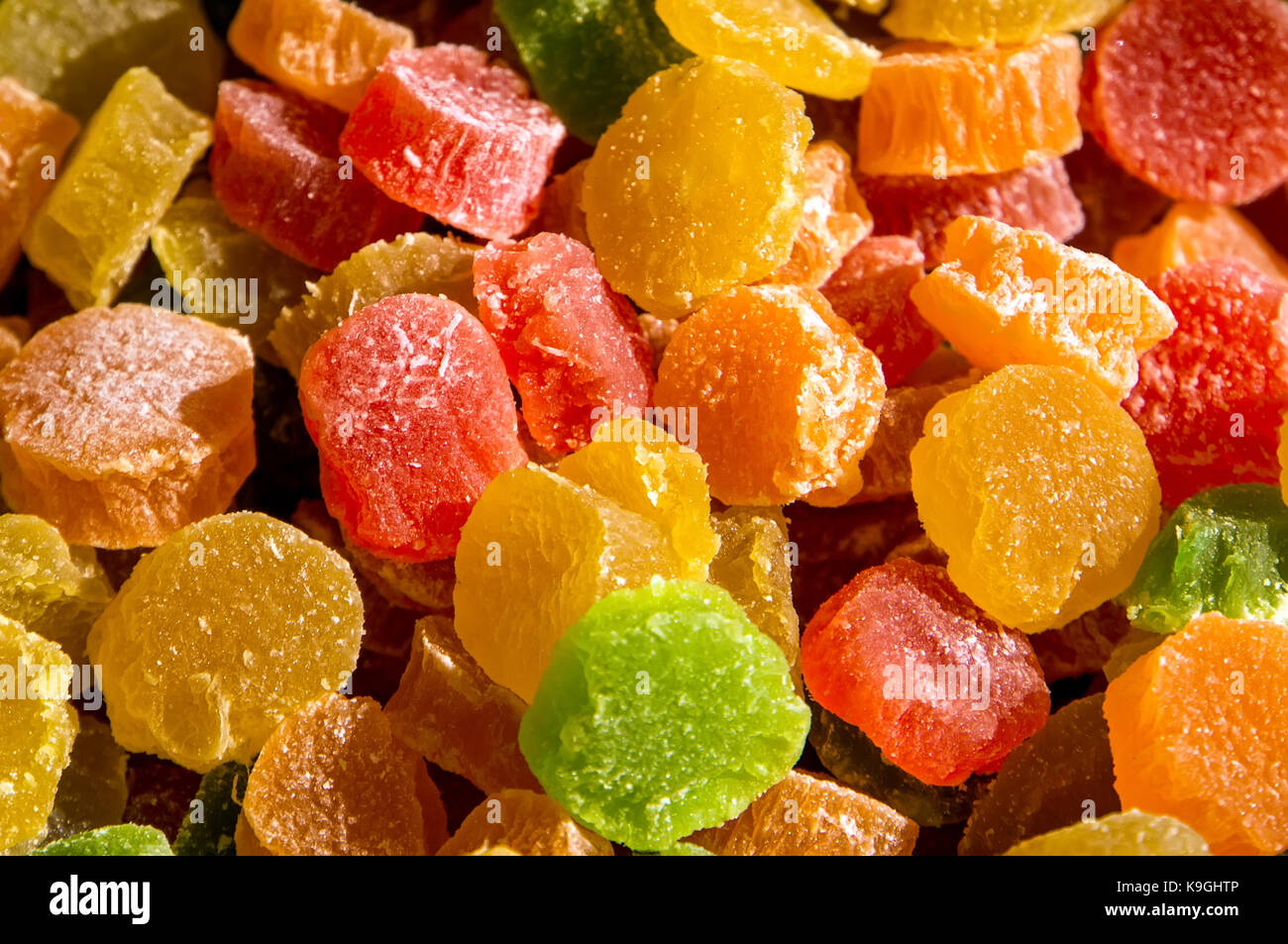 Colorful mix fruit jelly candy. Candied fruits in the background ...
