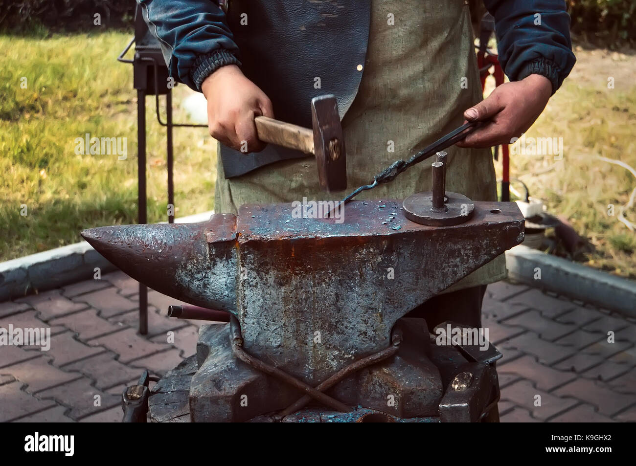 Blacksmith forges a red-hot iron in the forge. Forging hammer of metal ...