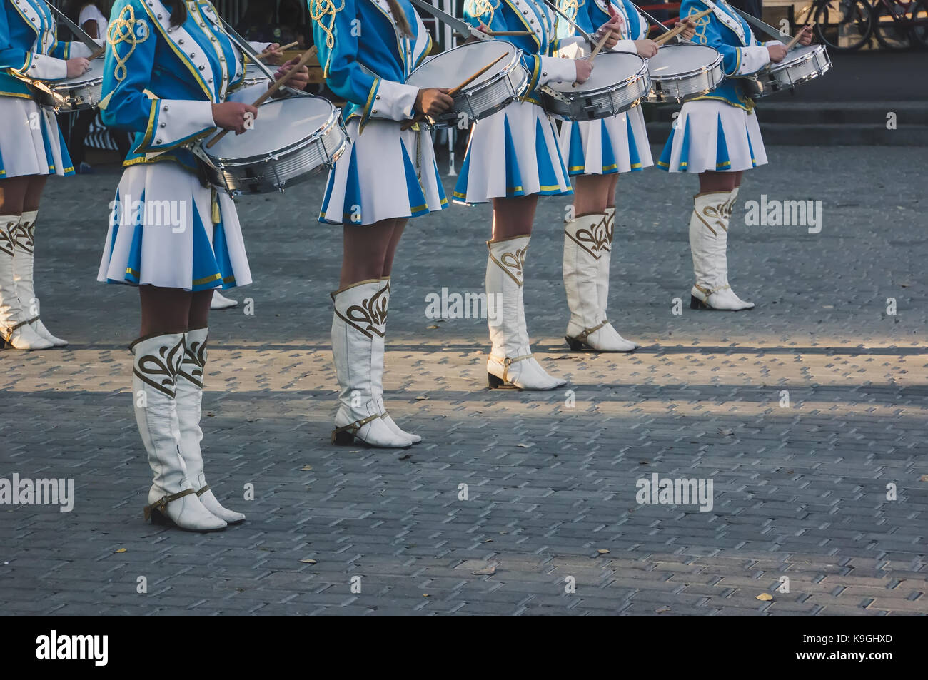 Young drummers at a military parade. Girl in a beautiful dress standing ...
