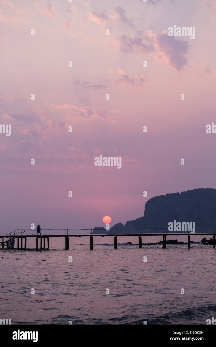 Vertical seascape with the pier, sea and castle rock of Alanya at ...