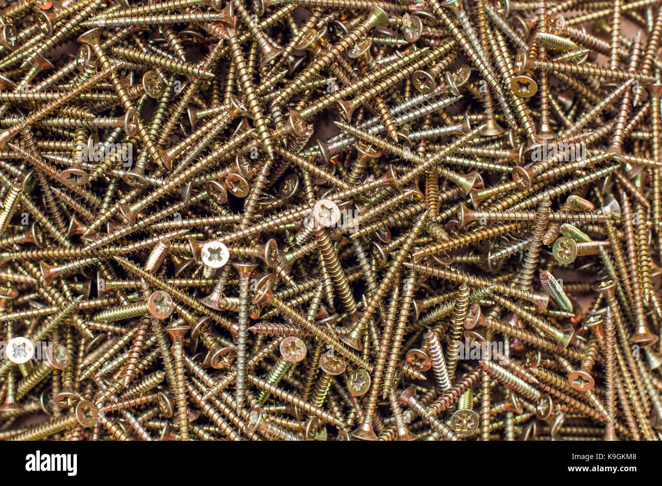Industrial background texture of gold screws Stock Photo - Alamy