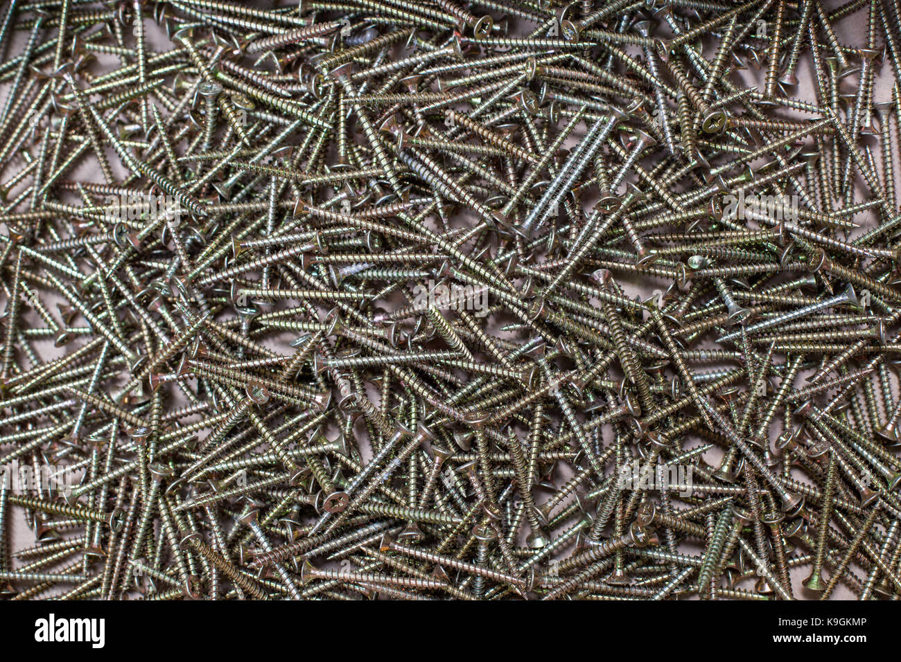Industrial background texture of gold and silver screws Stock Photo - Alamy