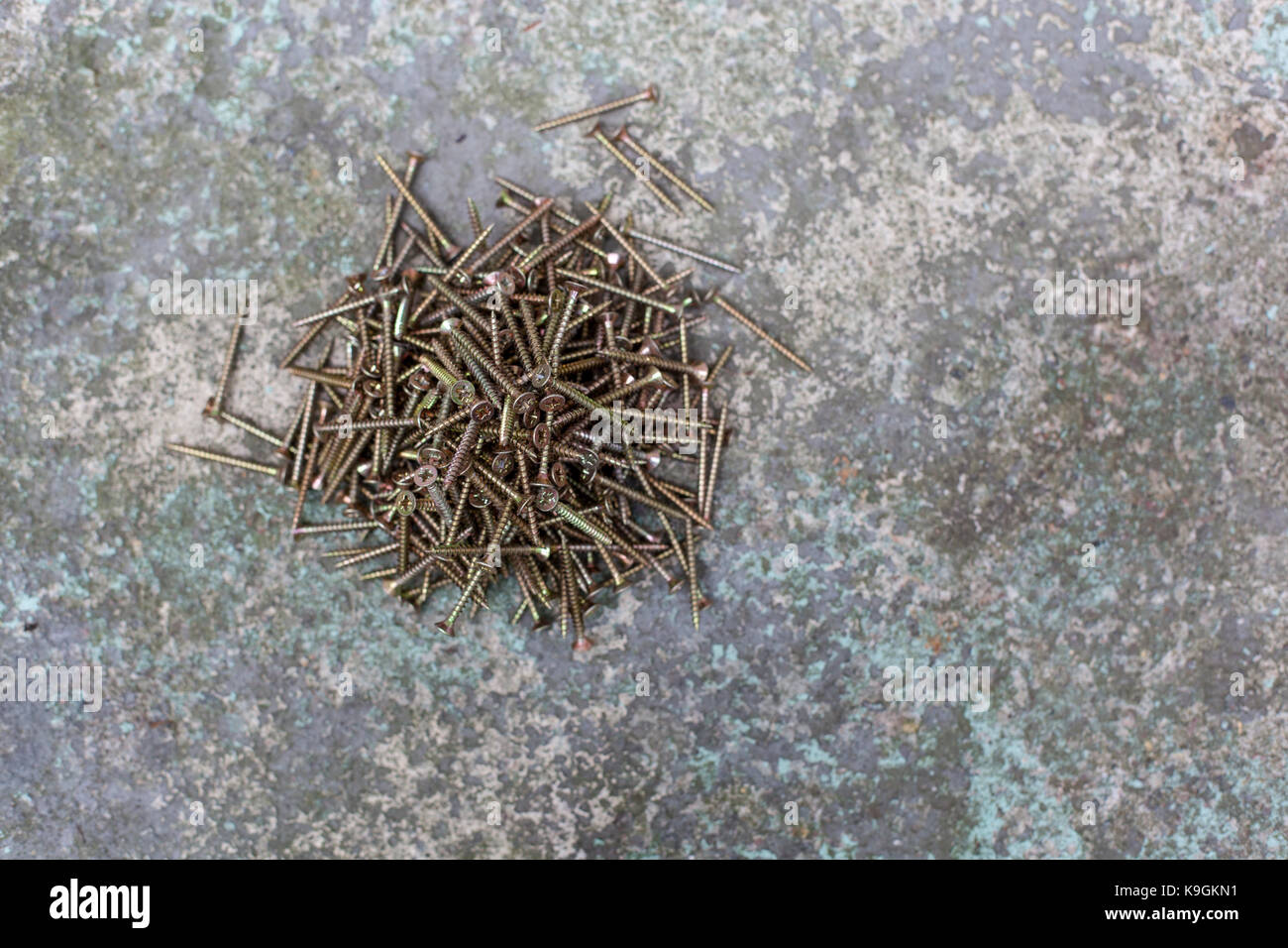 Industrial background texture of gold screws on the concrete background ...