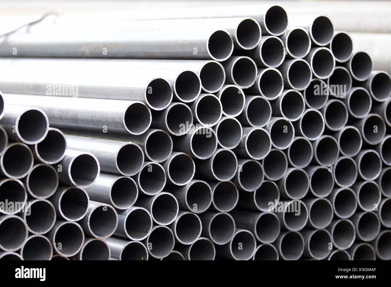 Metal profile pipe of round section in packs at the warehouse of metal ...