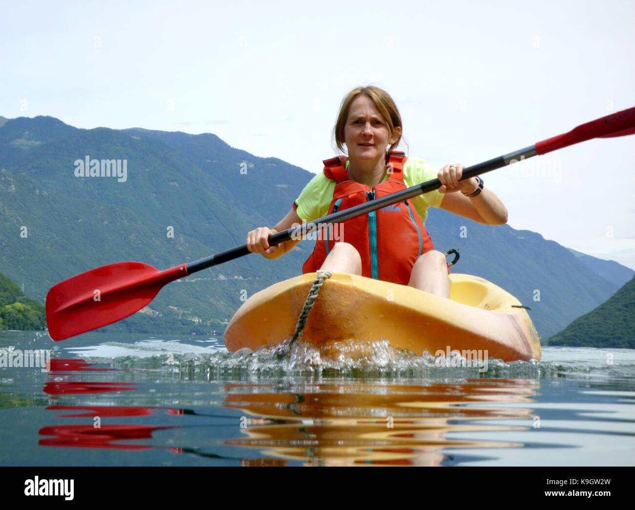 Woman kayaking on Lake Idro Stock Photo - Alamy