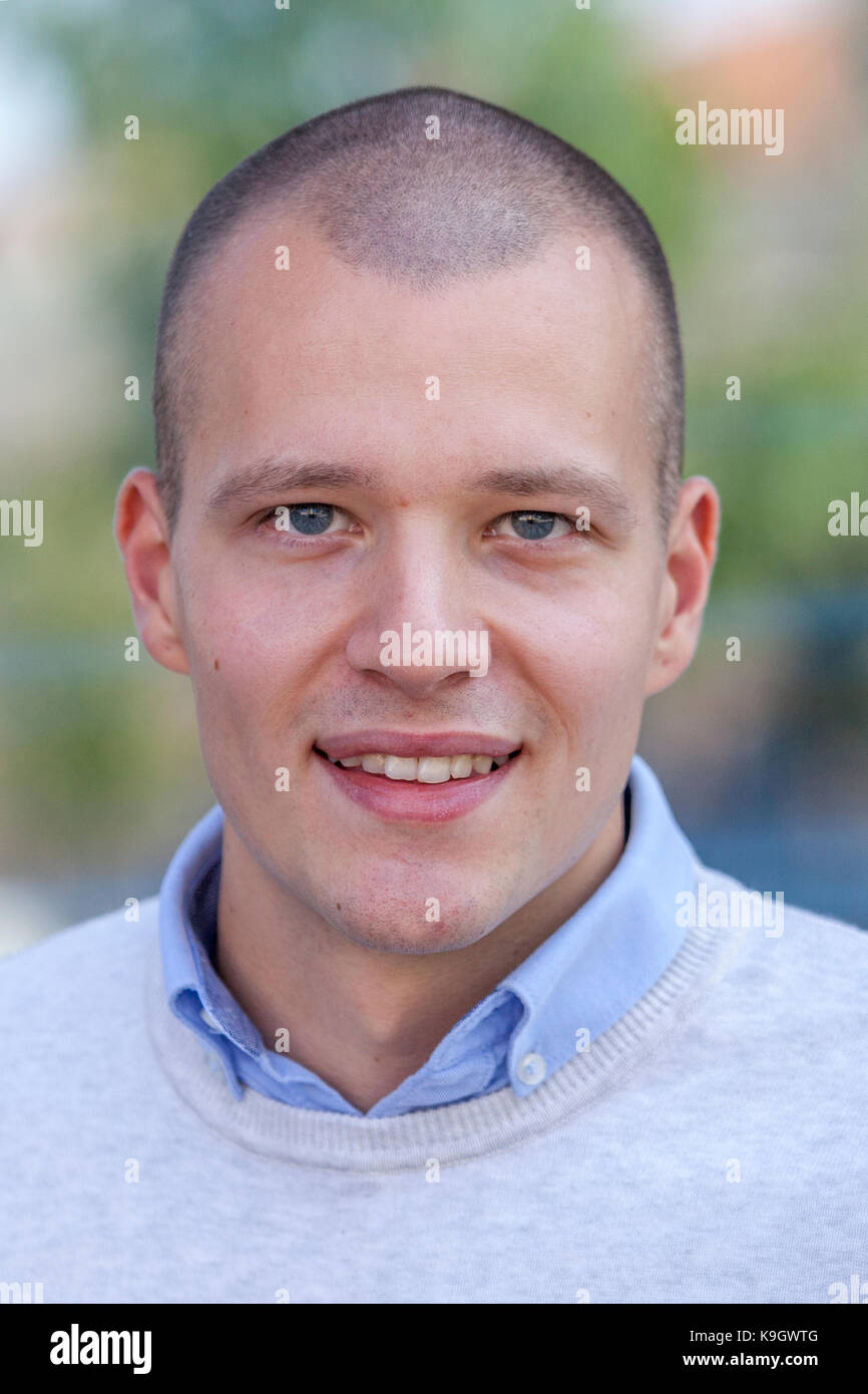 Close up portrait of handsome young businessman smiling by building in ...