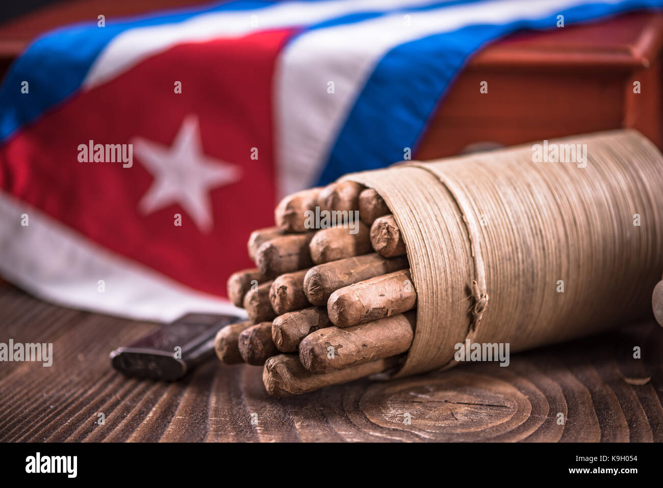 Cuban cigar in ashtray on wooden table, items related to travel to Cuba ...
