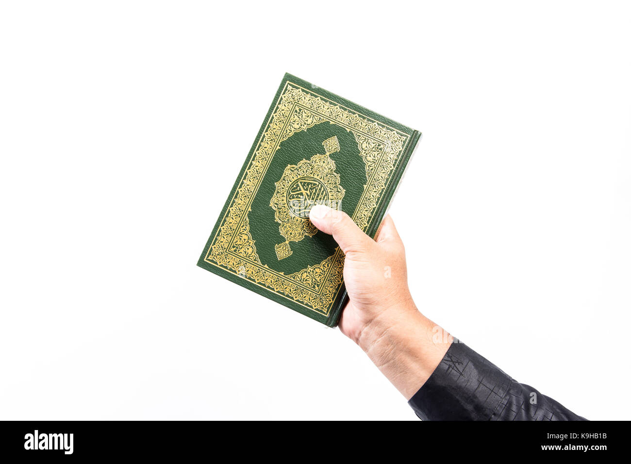 Koran in hand , Quran in hand - holy book of Muslims , on white ...