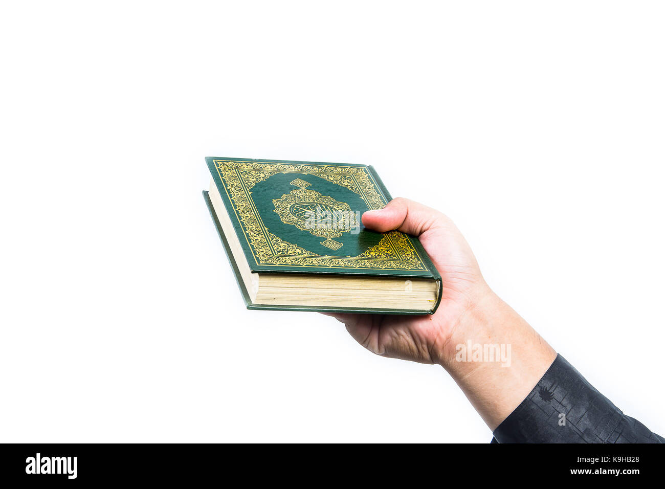 Koran in hand , Quran in hand - holy book of Muslims , on white ...