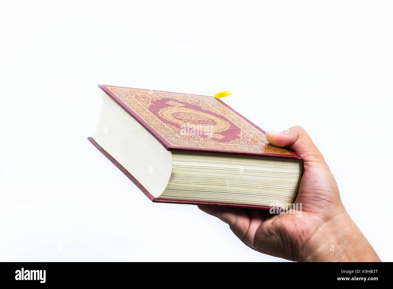 Koran in hand , Quran in hand - holy book of Muslims , on white ...