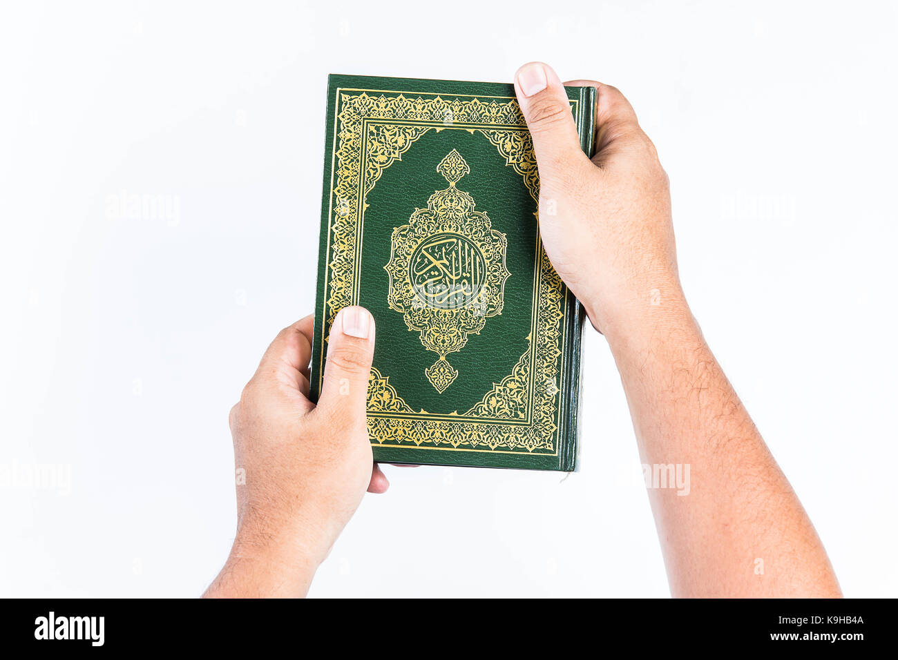 Koran in hand , Quran in hand - holy book of Muslims , on white ...