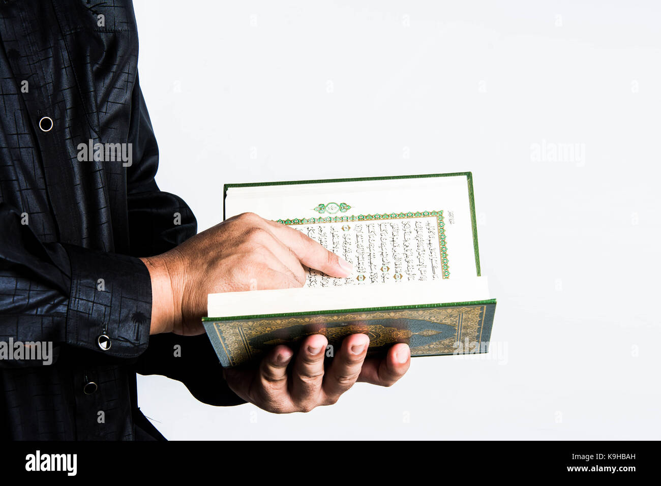 Koran in hand , Quran in hand - holy book of Muslims , on white ...