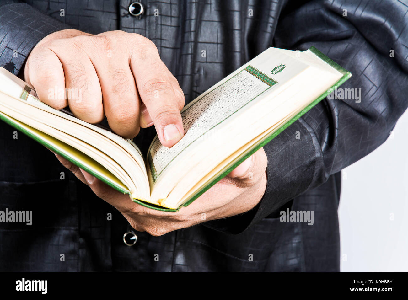 Koran in hand , Quran in hand - holy book of Muslims , on white ...