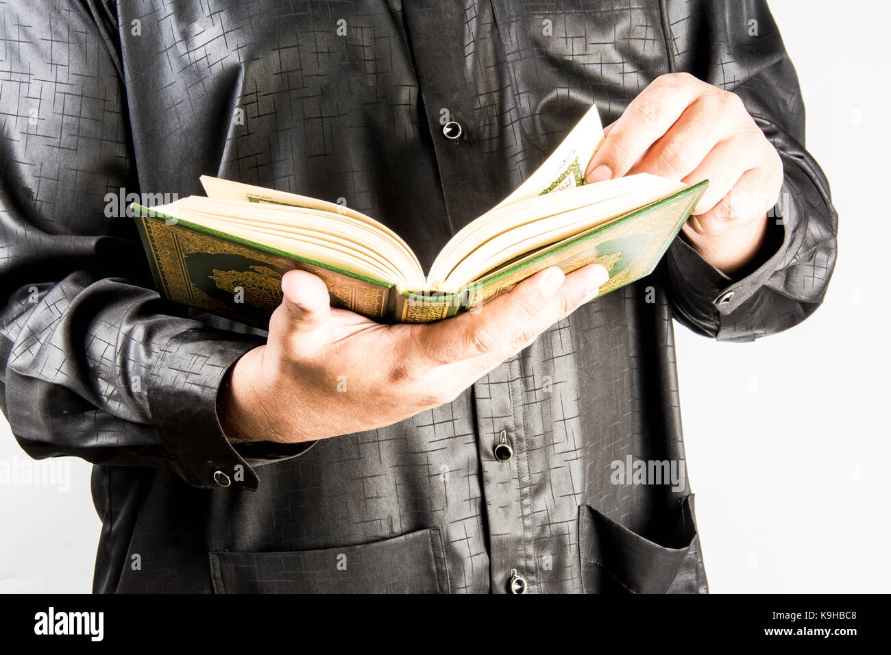 Koran in hand , Quran in hand - holy book of Muslims , on white ...