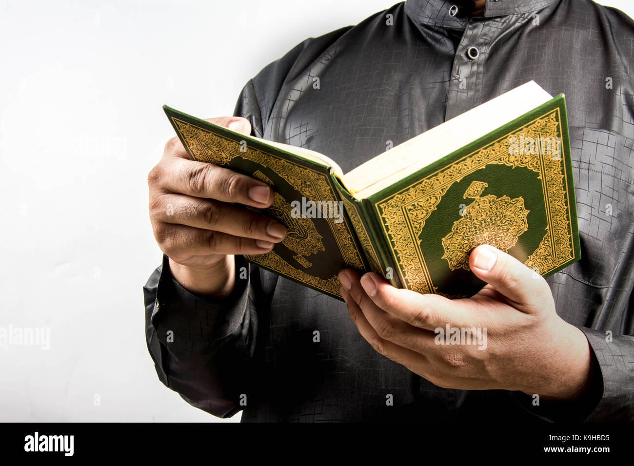 Koran in hand , Quran in hand - holy book of Muslims , on white ...