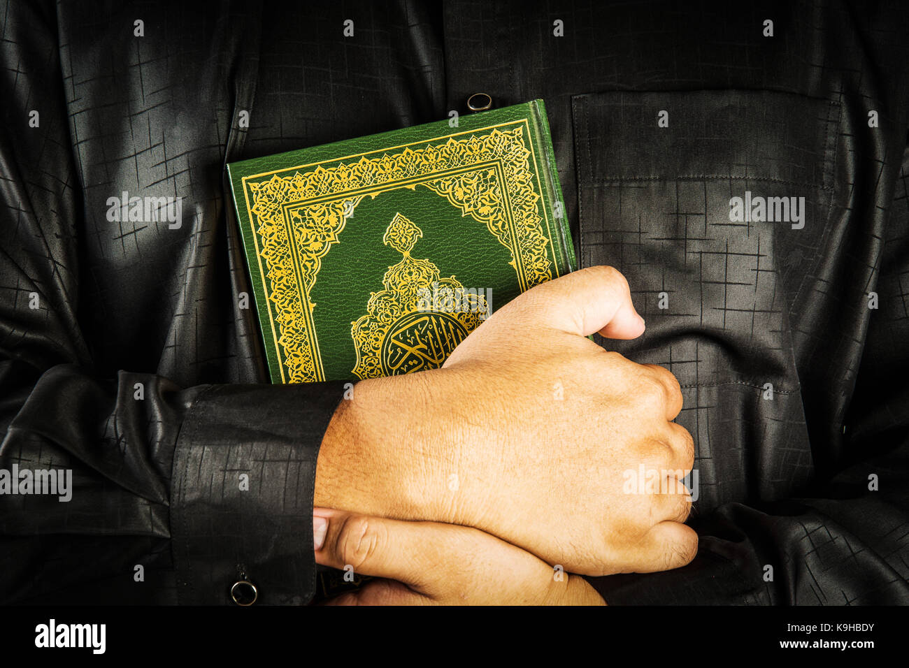 Koran in hand , Quran in hand - holy book of Muslims , on white ...