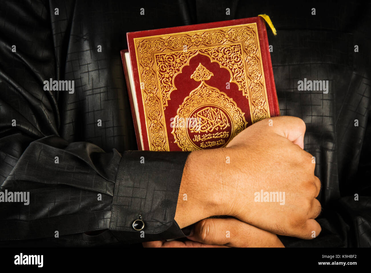 Koran in hand , Quran in hand - holy book of Muslims , on white ...