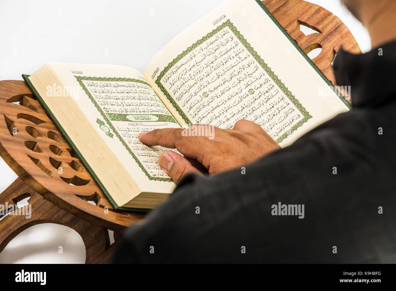 Koran in hand , Quran in hand - holy book of Muslims , on white ...