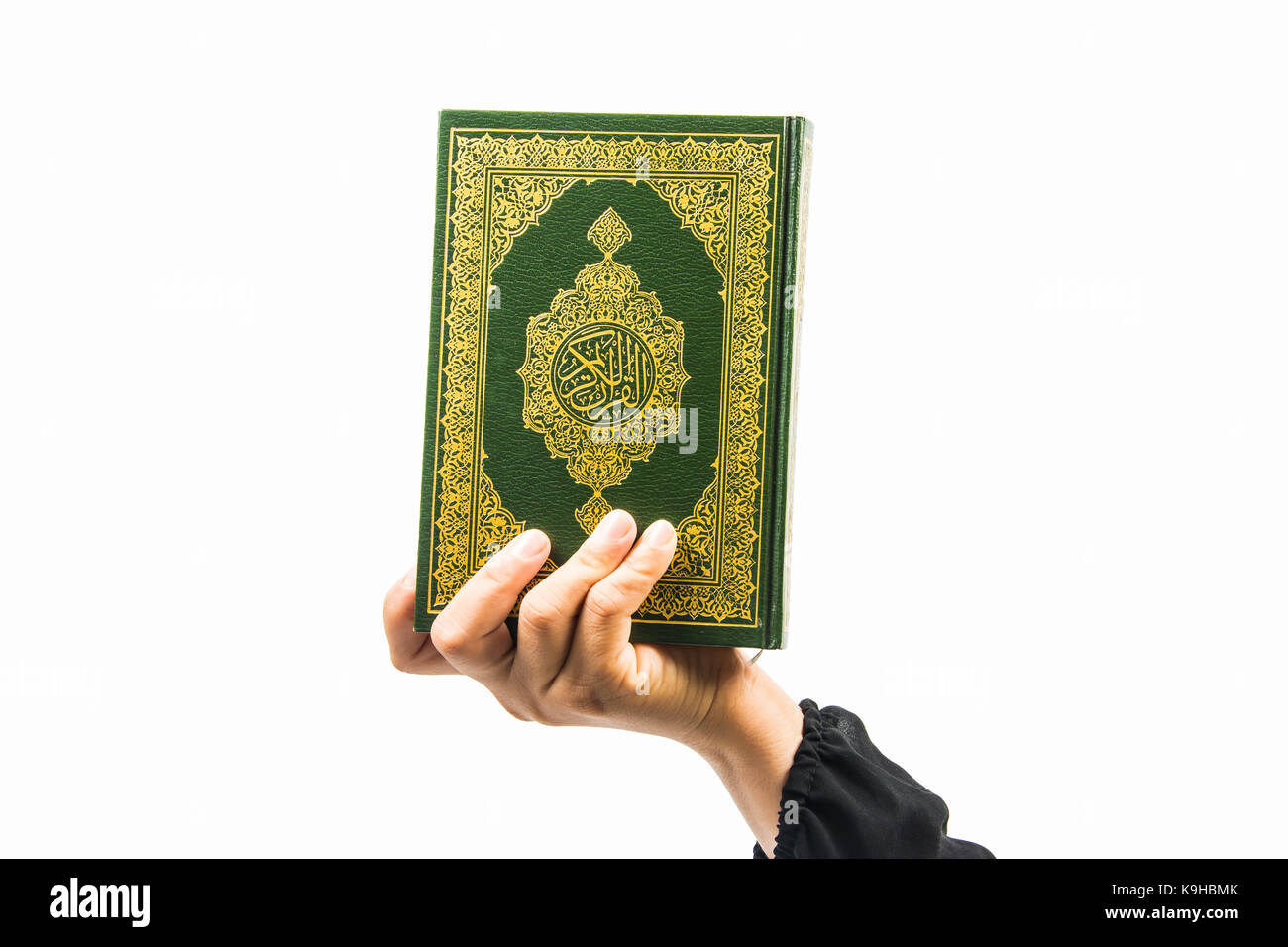Koran in hand , Quran in hand - holy book of Muslims , on white ...