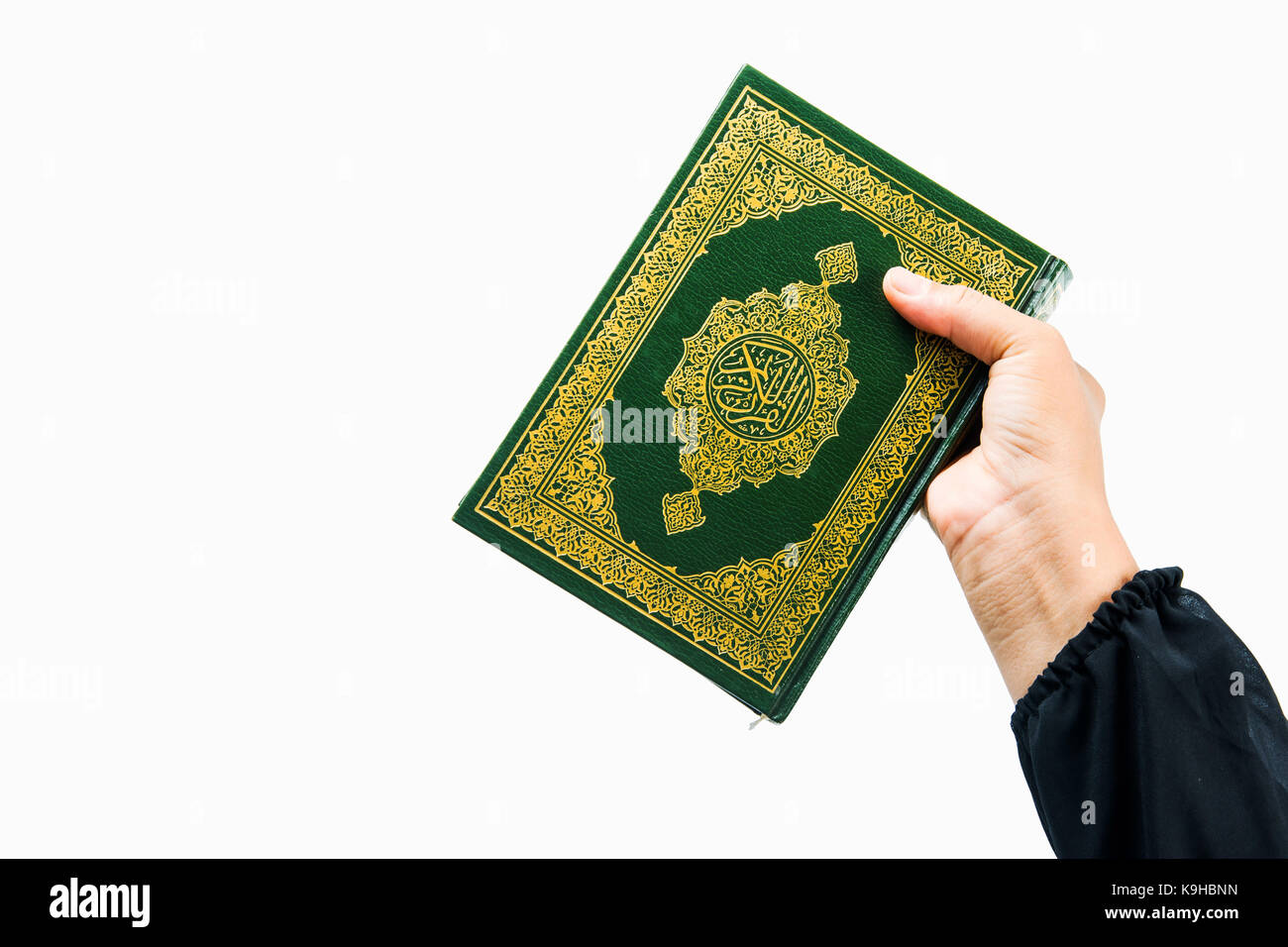 Koran in hand , Quran in hand - holy book of Muslims , on white ...