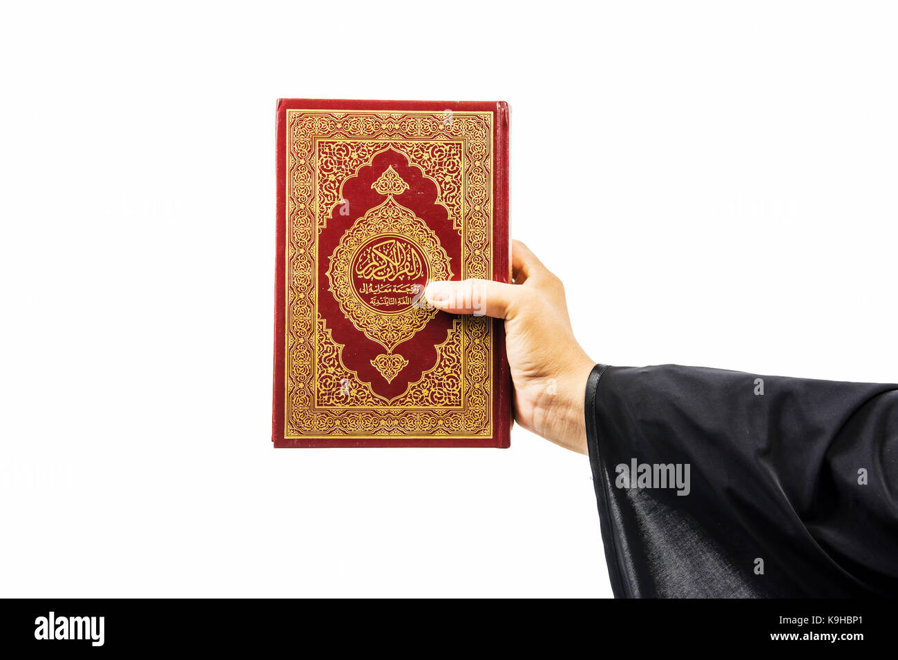 Koran in hand , Quran in hand - holy book of Muslims , on white ...