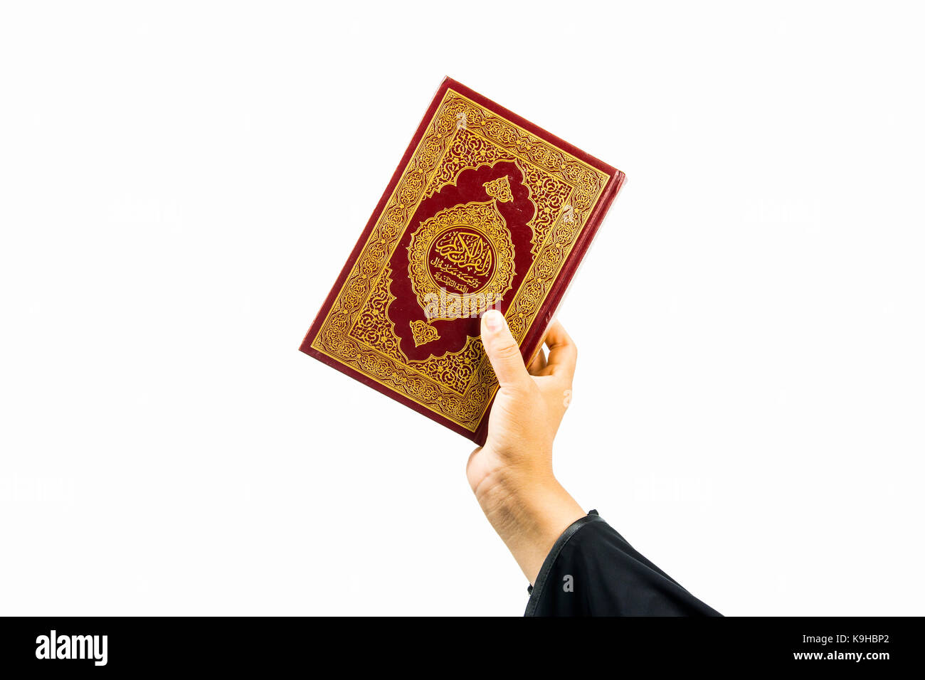 Koran in hand , Quran in hand - holy book of Muslims , on white ...