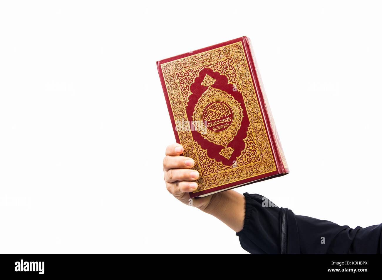 Koran in hand , Quran in hand - holy book of Muslims , on white ...