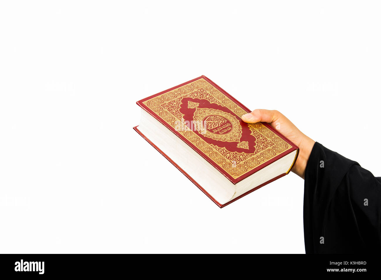 Koran in hand , Quran in hand - holy book of Muslims , on white ...