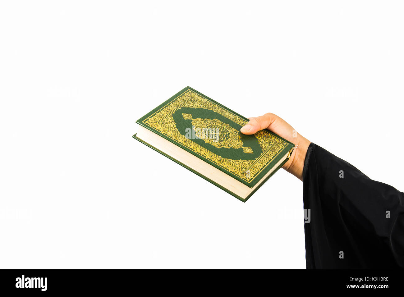 Koran in hand , Quran in hand - holy book of Muslims , on white ...