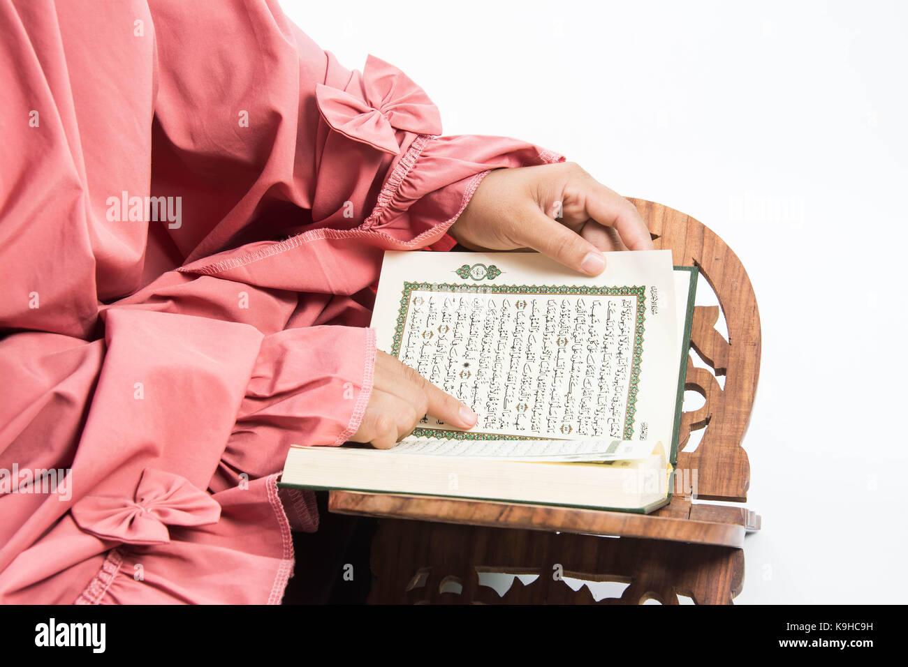 Koran in hand , Quran in hand - holy book of Muslims , on white ...