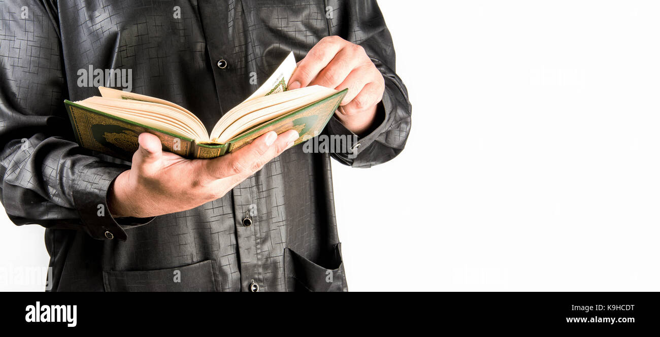 Koran in hand , Quran in hand - holy book of Muslims , on white ...
