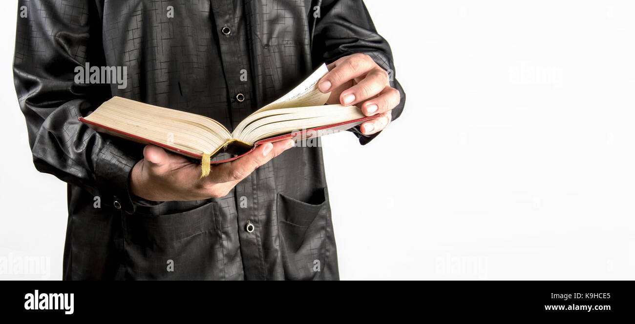 Koran in hand , Quran in hand - holy book of Muslims , on white ...