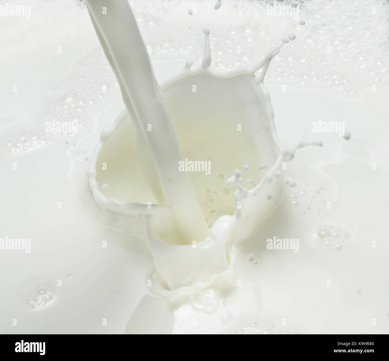 Pouring milk and milk splash. Close-up Stock Photo - Alamy
