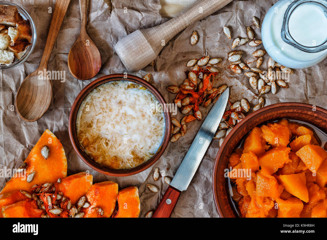 Healthy breakfast. Pumpkin porridge with milk. background of crumpled ...