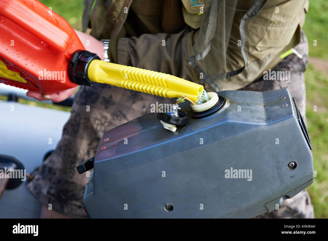 Fisherman pours petrol into the engine of a fishing boat Stock Photo ...