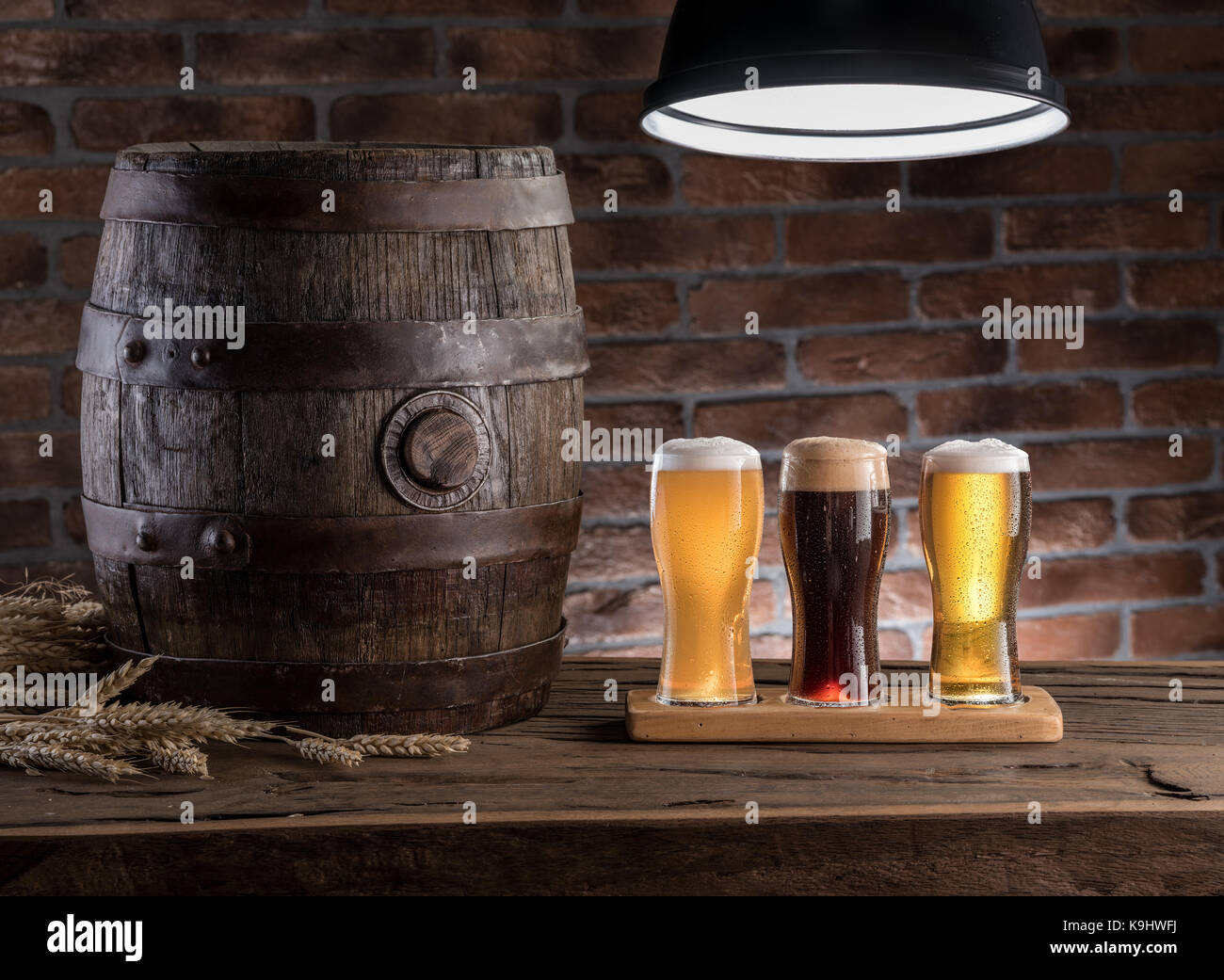 Glasses of beer and ale barrel on the wooden table. Craft brewery Stock ...