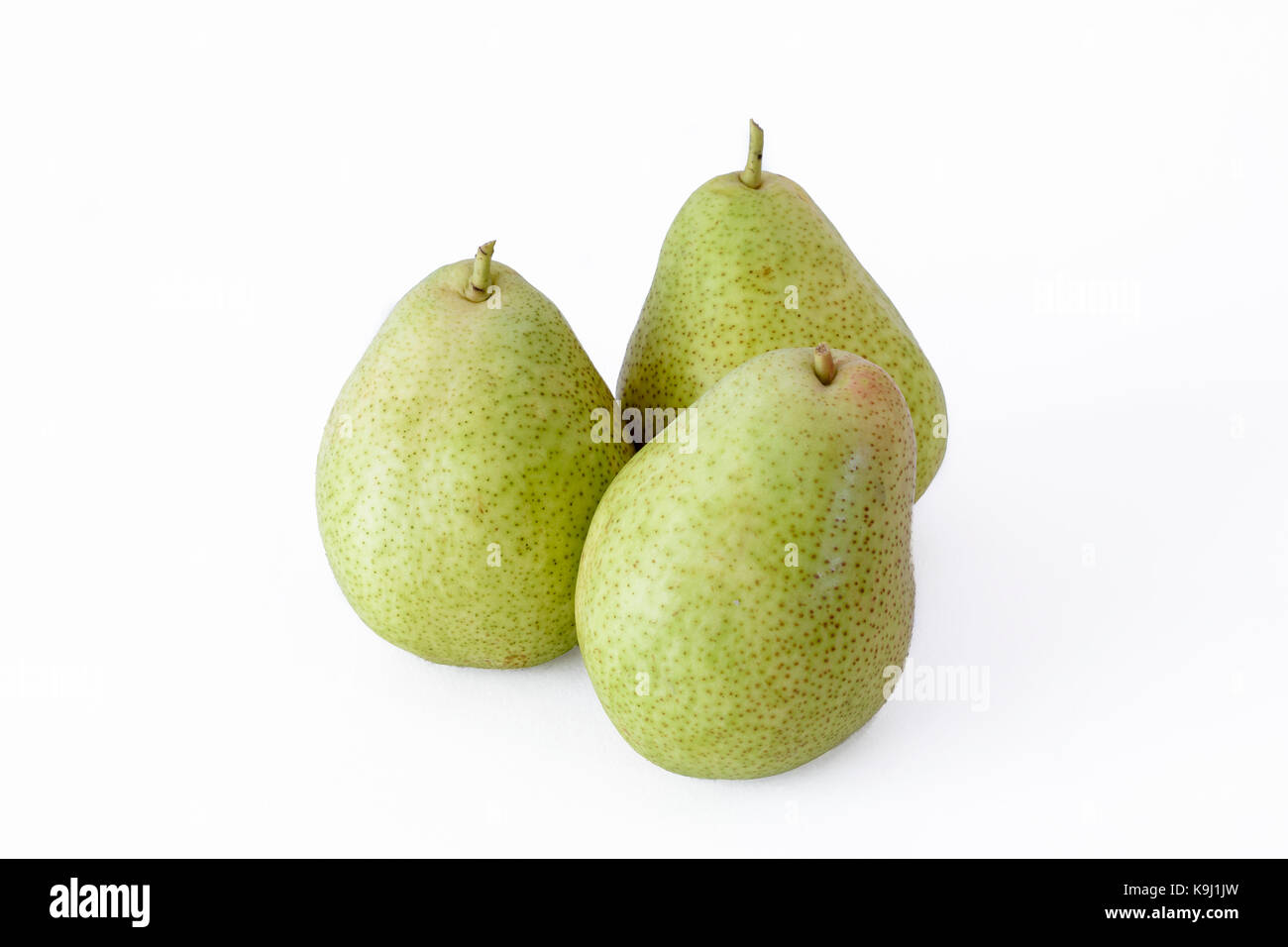 Three Green Pears on a white background Stock Photo - Alamy