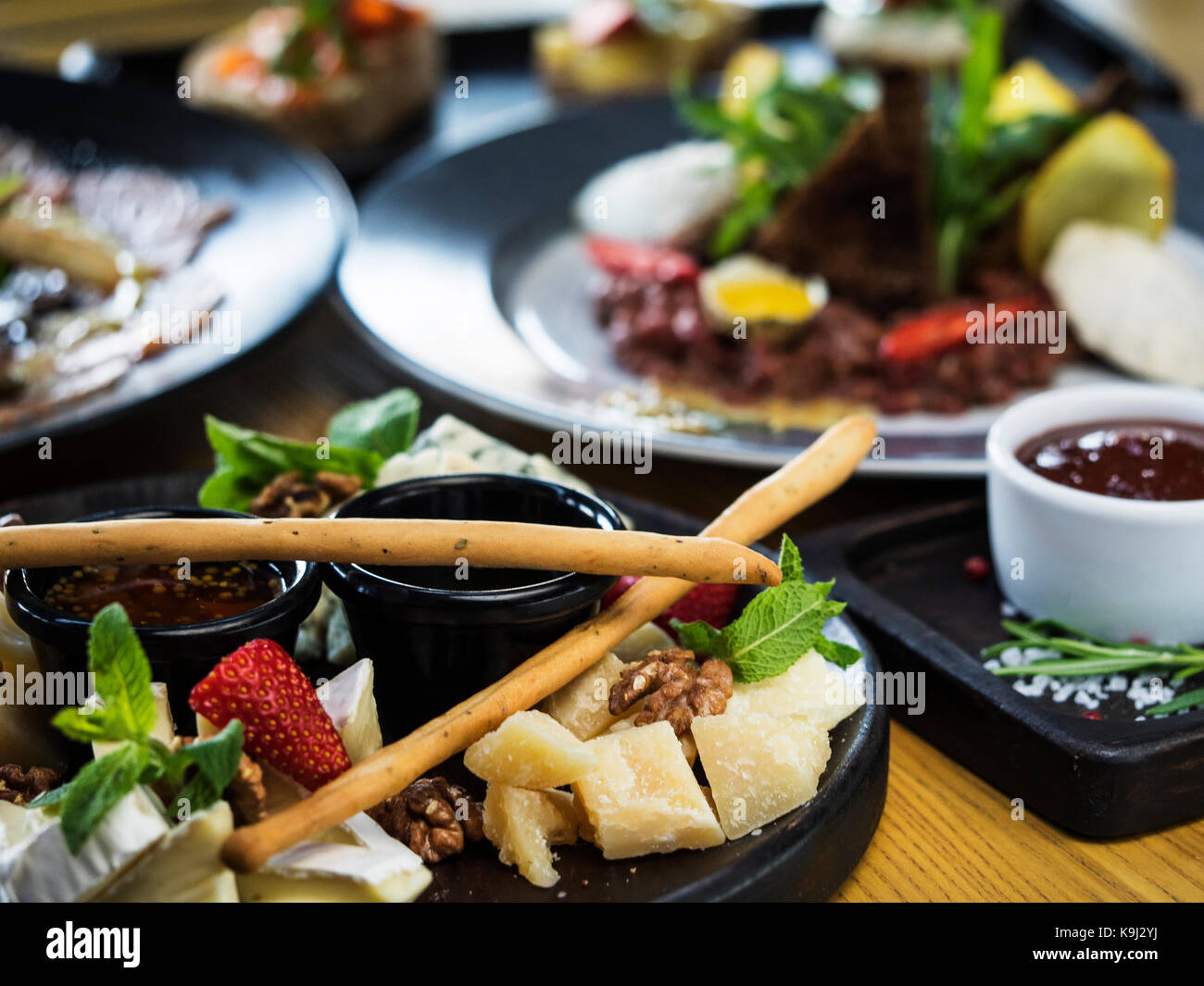 Italian chesse plate on black dish Stock Photo - Alamy