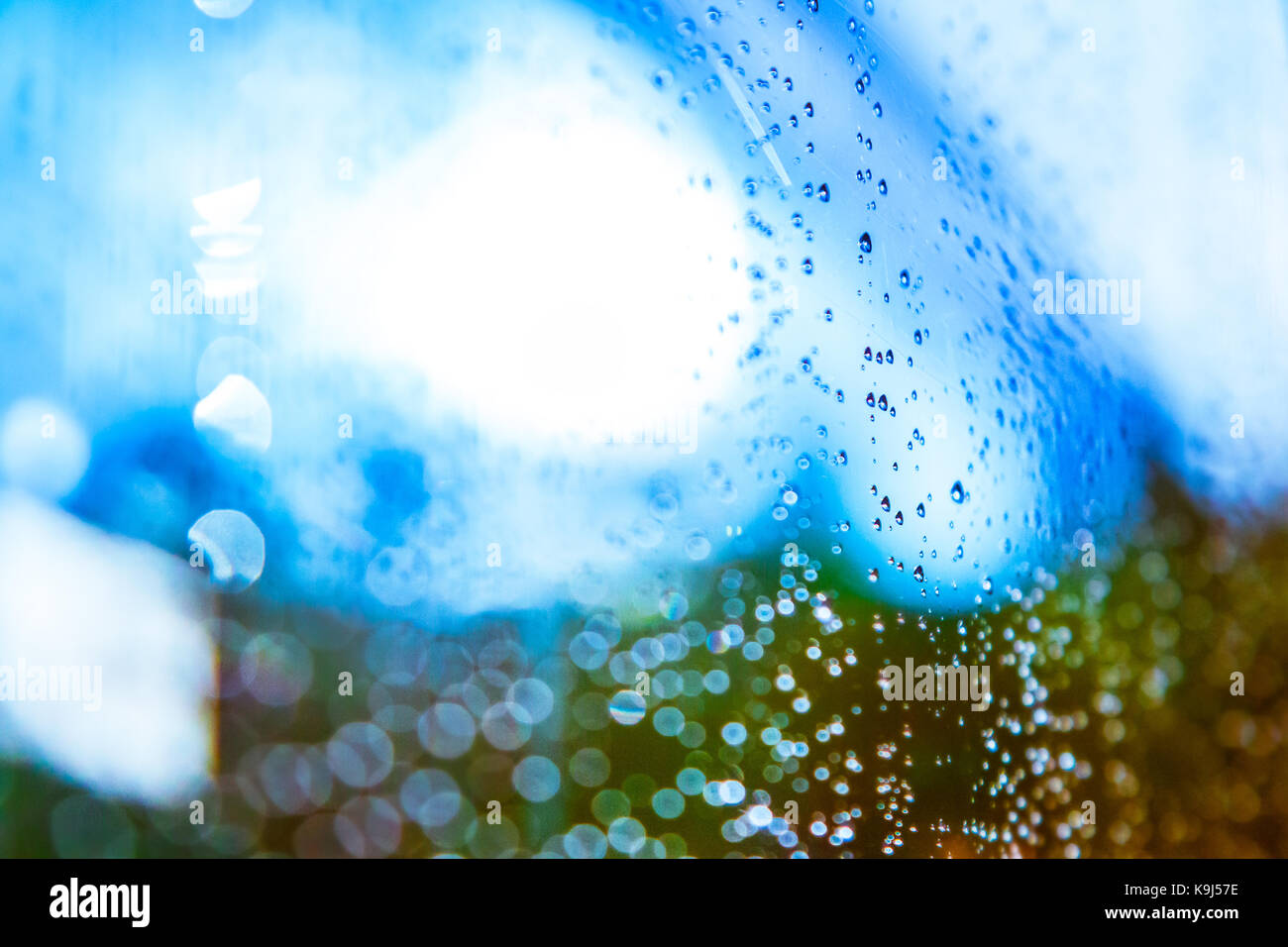 colorful selective focus of rain water drops on glass window, good for ...