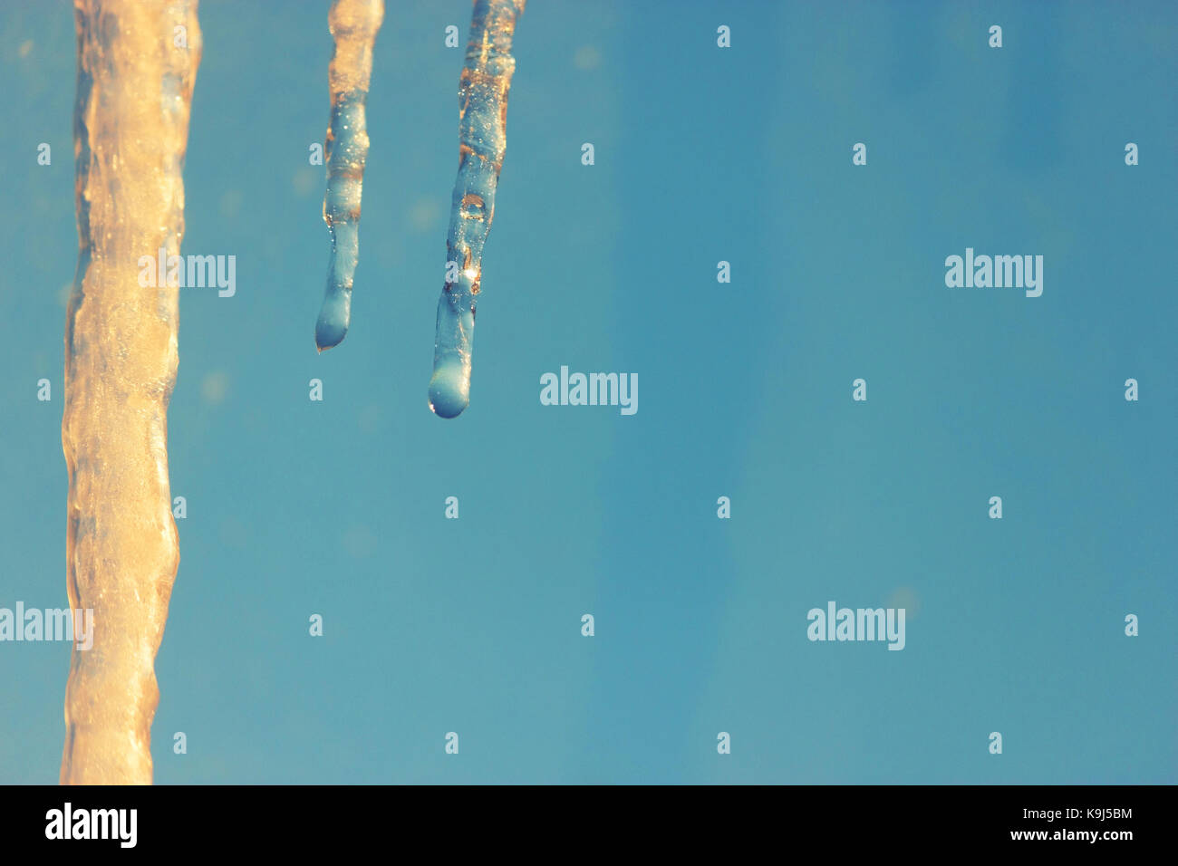 icecle on a background of blue sky. winter concept Stock Photo - Alamy