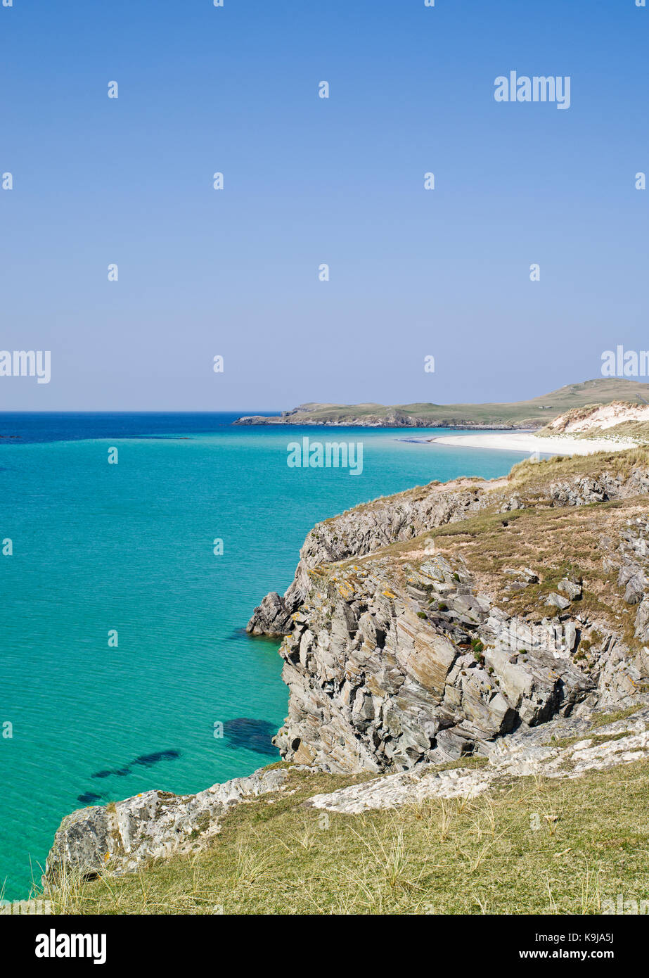 View from a cliff over the turquoise coloured sea and white sand beach ...