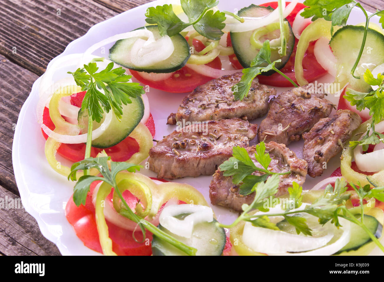 Grilled pork fillet meat and vegetables in plate Stock Photo - Alamy