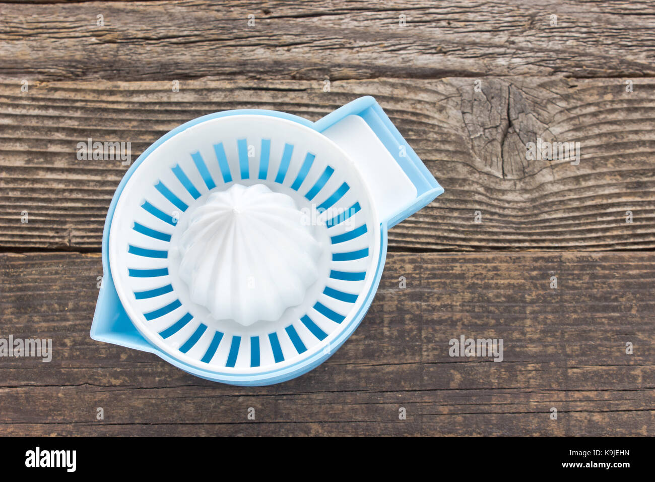 Plastic lemon squeezer on wooden background Stock Photo - Alamy
