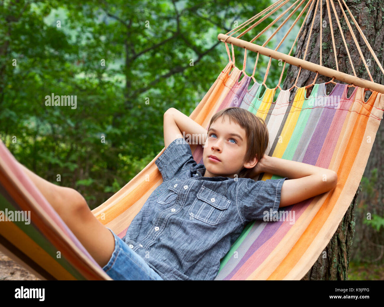 Boy lying in hammock outdoors Stock Photo - Alamy