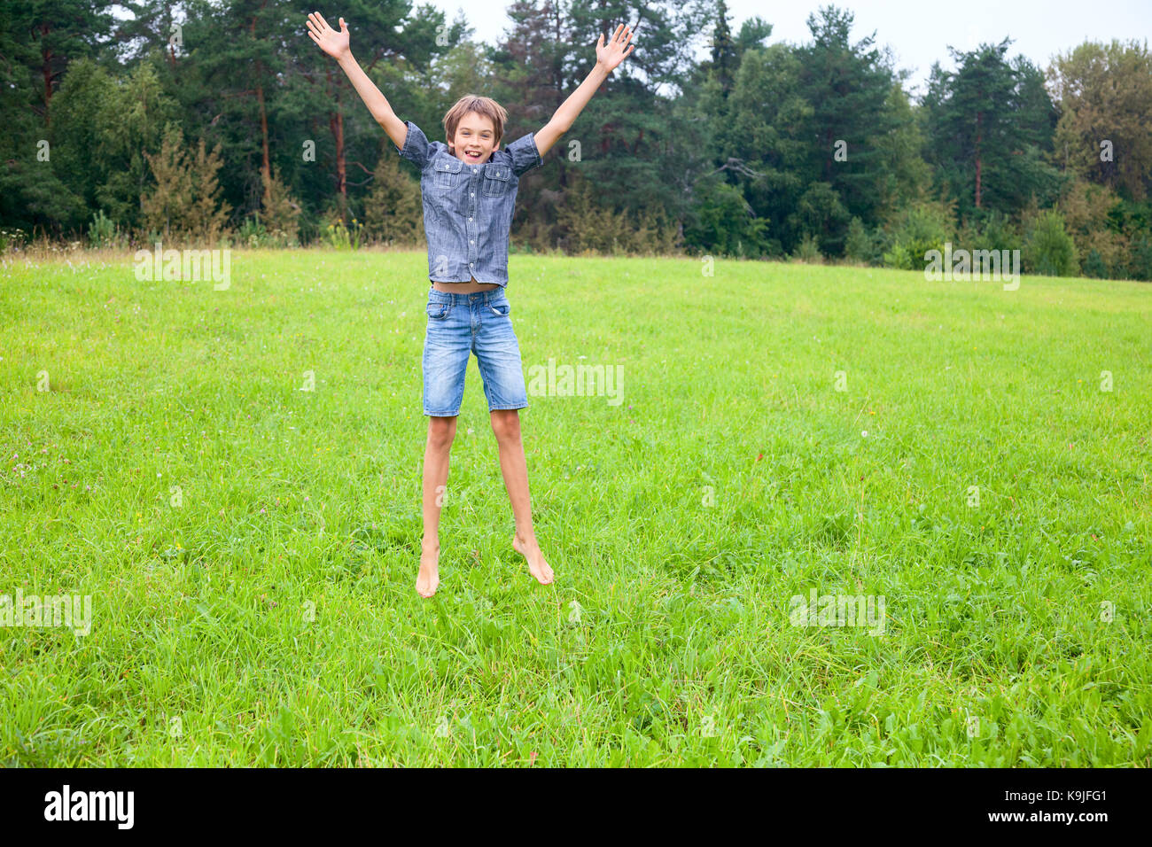 Boy jumping joy outdoors hi-res stock photography and images - Alamy