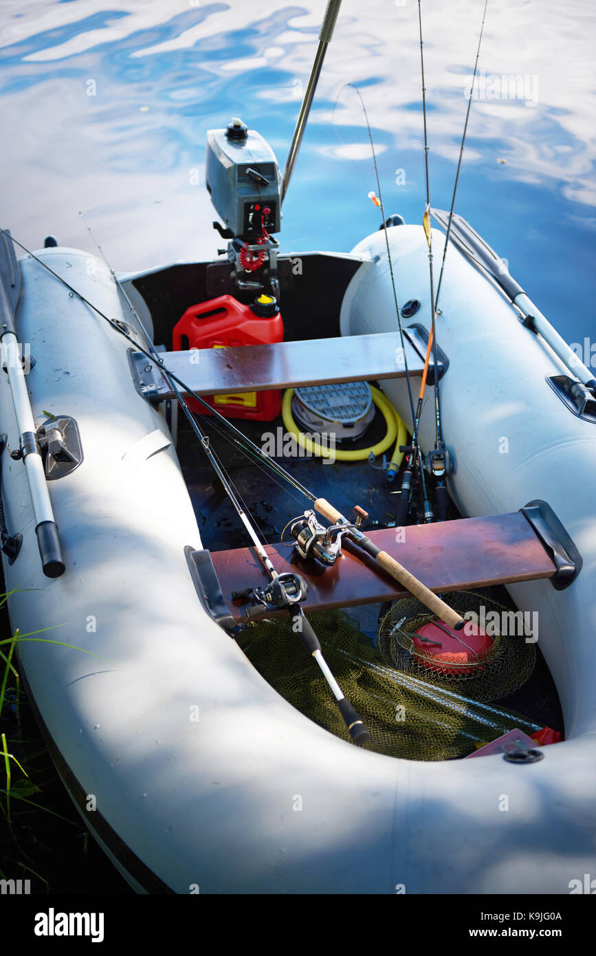Fishing rods with spinning reels in a boat Stock Photo - Alamy