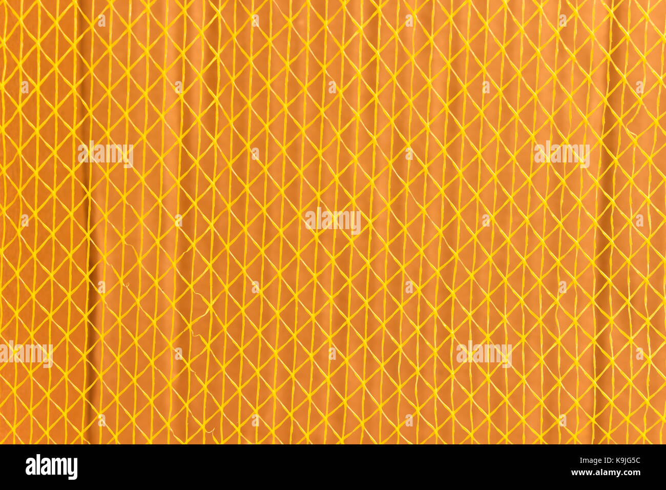 Orange texture plastic net background Stock Photo - Alamy